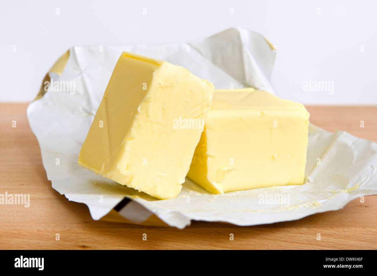 Open pack of butter on wooden chopping board Stock Photo: 67428103 - Alamy