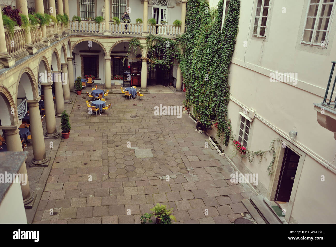 old courtyard with arches and white house with green ivy Stock Photo ...