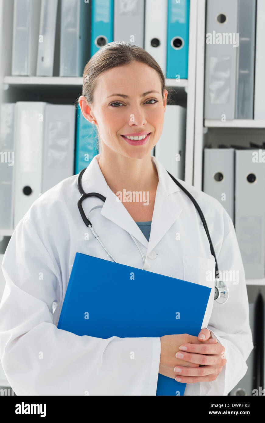 Beautiful female doctor holding folder Stock Photo - Alamy