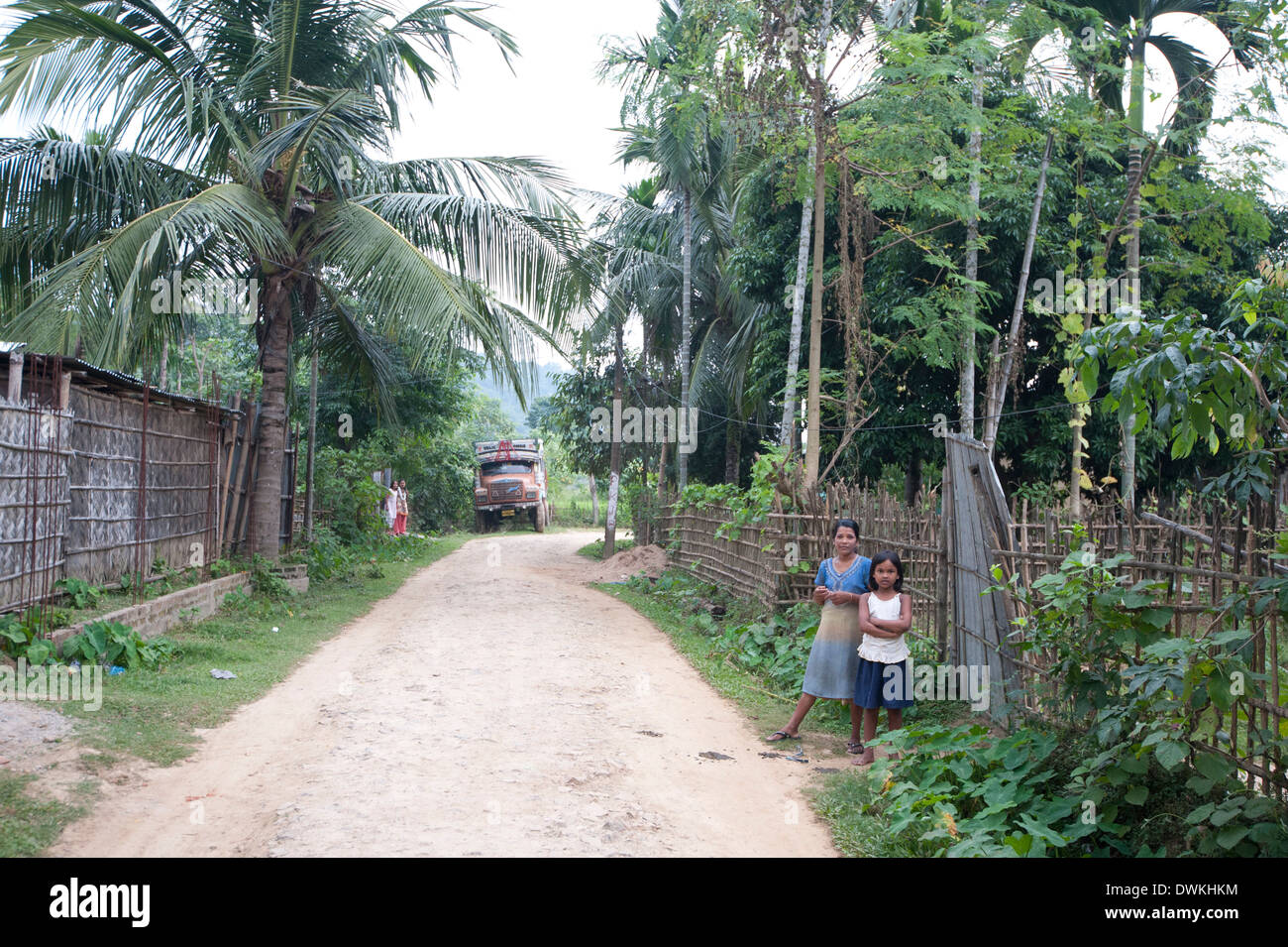 Mother and daughter in typical rural village street, Bijaynagar, Assam ...