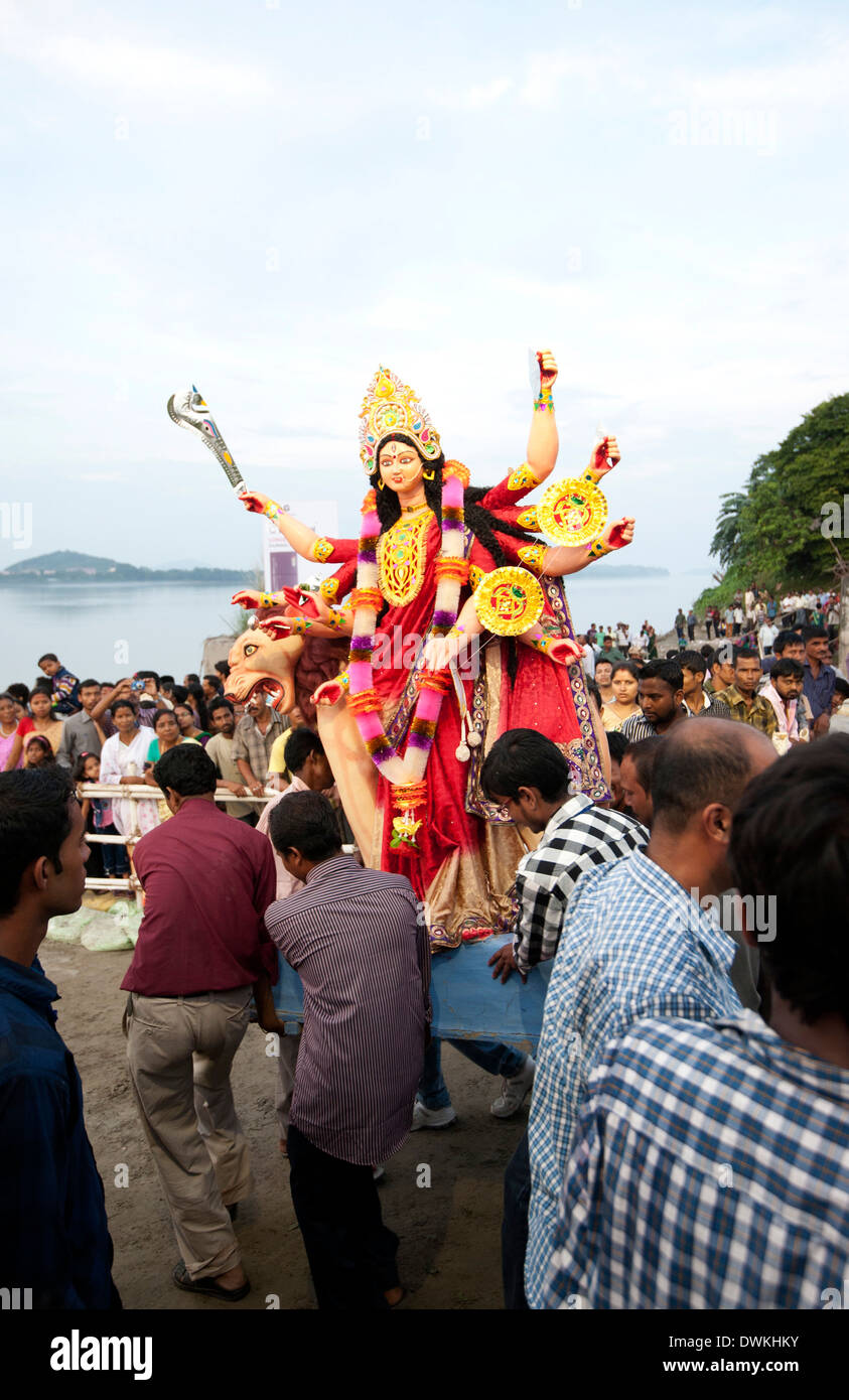 Durga puja deity, made from river mud, being taken to the Brahmaputra ...