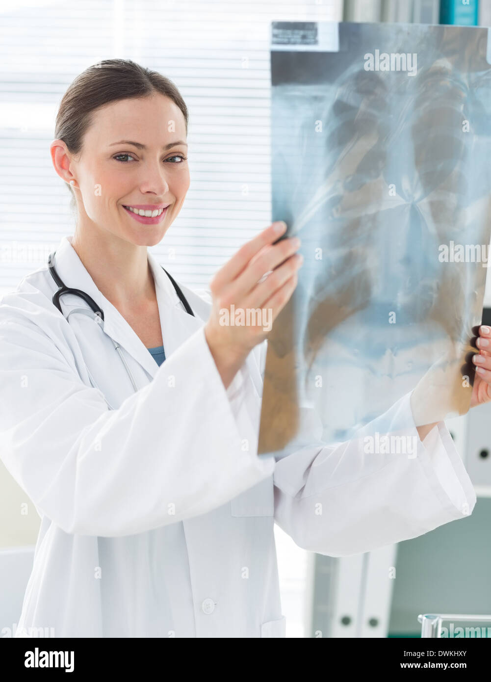 Beautiful doctor holding Xray report Stock Photo - Alamy