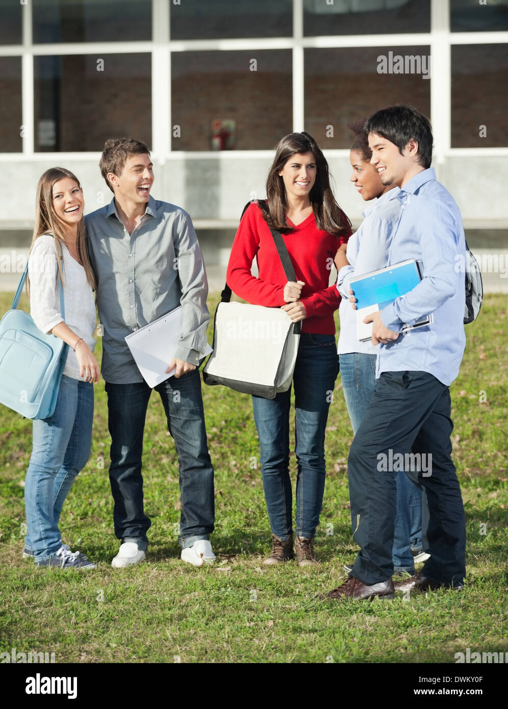 Happy Students Standing On College Campus Stock Photo - Alamy