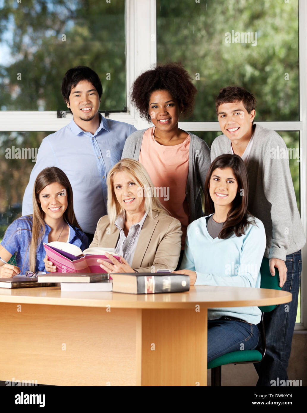 University Students And Professor With Books In Classroom Stock Photo ...