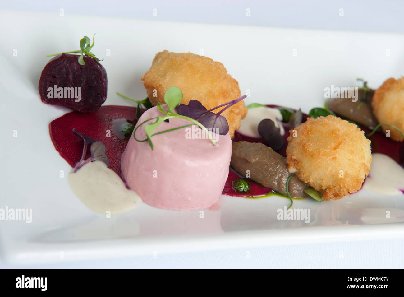 Goats cheese croquette, pickled beetroot mousse, caper and raisin puree ...