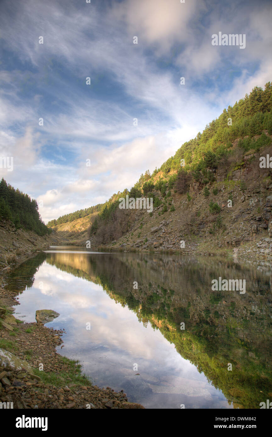 The image produced in portrait format of a disused quarry that has ...