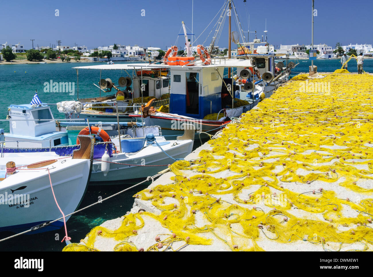 Yellow fishing nets drying in the sun in the town of Pollonia, Milos ...