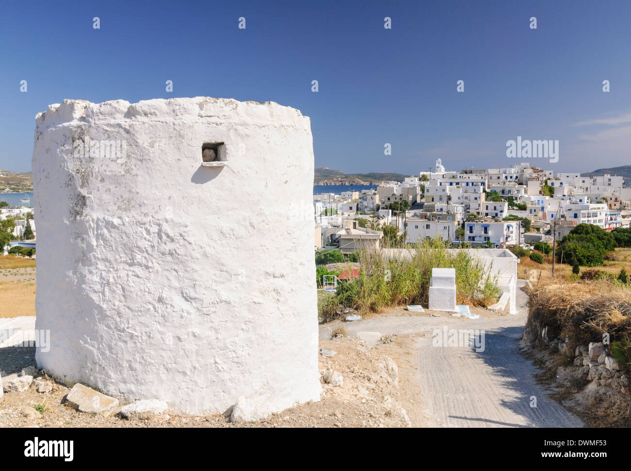 Old base of a windmill looks over the port town of Adamas on Milos ...