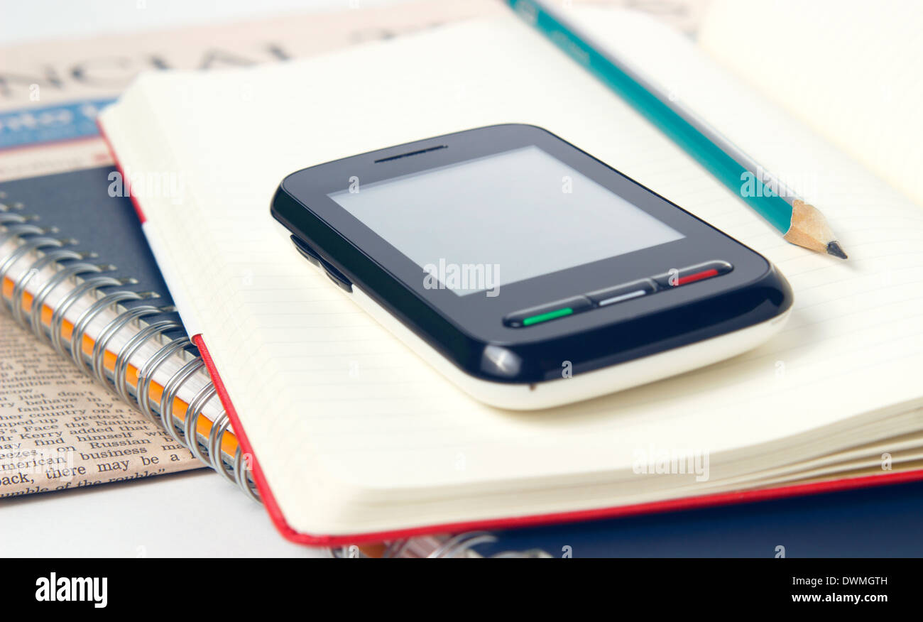smart phone with touch screen on open notepad Stock Photo - Alamy
