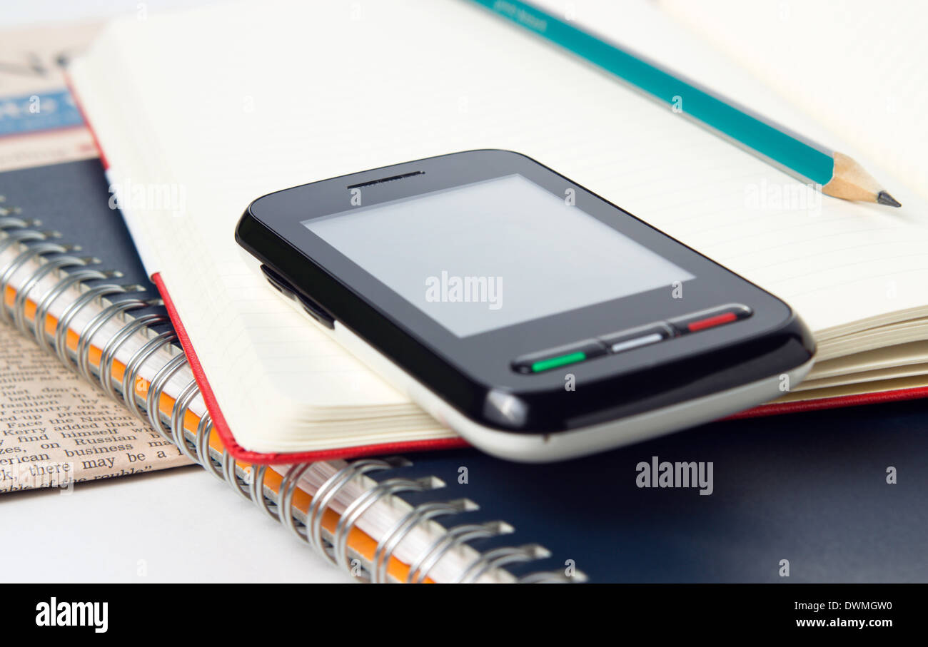 mobile phone on open notepad Stock Photo - Alamy