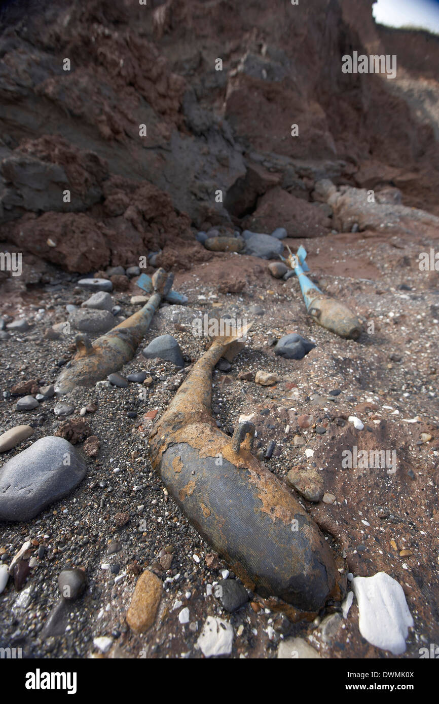 Unexploded bomb munitions exposed by coastal erosion on Mappleton beach ...