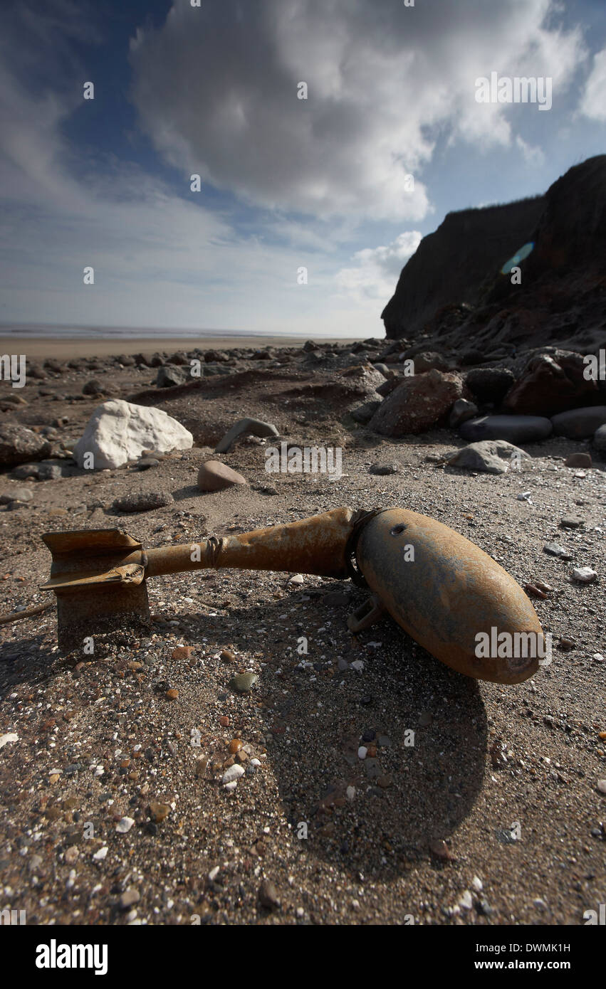 Unexploded bomb munitions exposed by coastal erosion on Mappleton beach ...