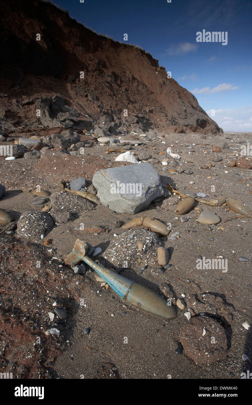 Unexploded bomb munitions exposed by coastal erosion on Mappleton beach ...