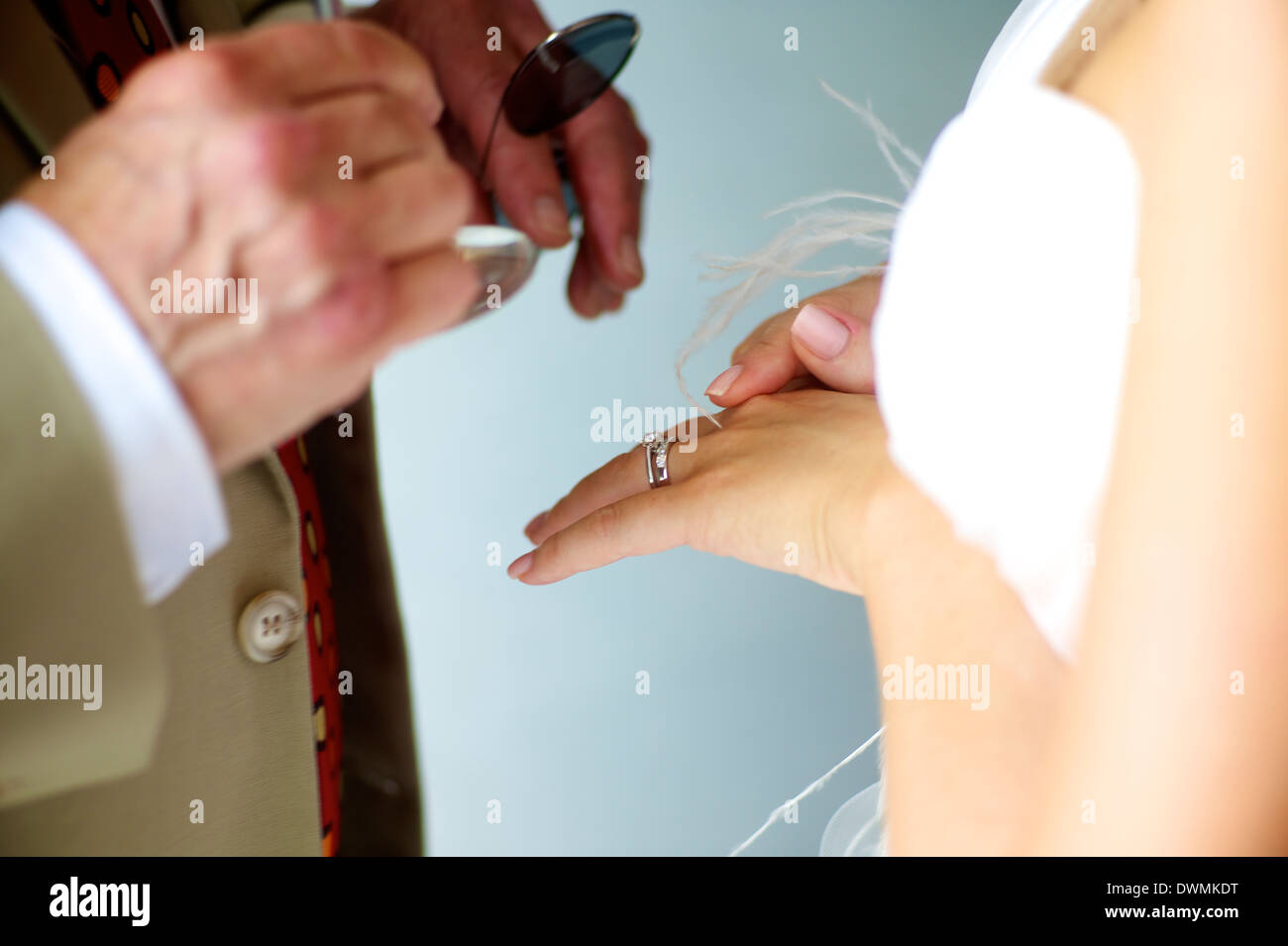 Bride showing off her wedding ring to guests at the wedding reception ...