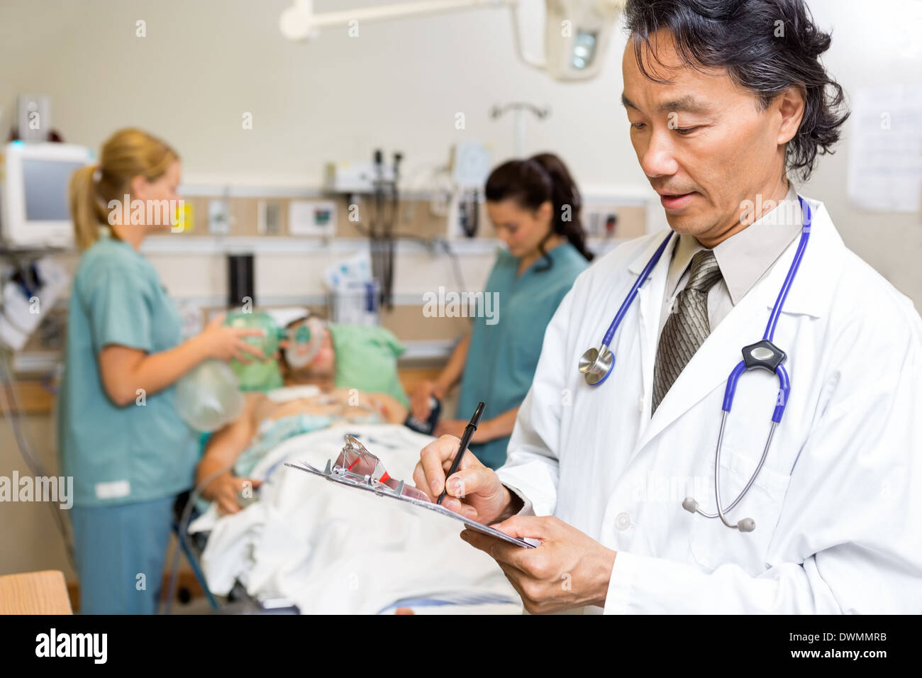 Doctor writing in patient chart hi-res stock photography and images - Alamy