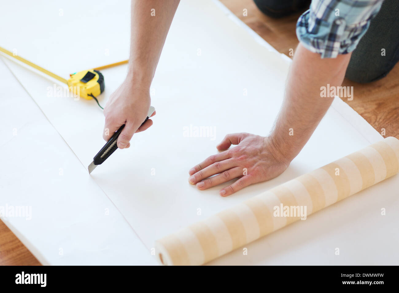 close up of male hands cutting wallpaper Stock Photo - Alamy