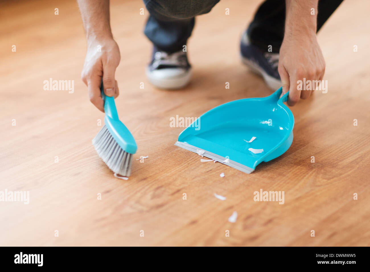 Man sweeping floor dustpan broom hi-res stock photography and images ...