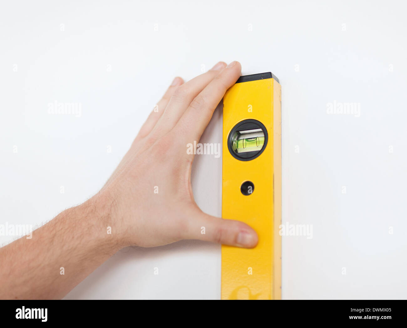 close up of male with spirit level mesuring wall Stock Photo - Alamy