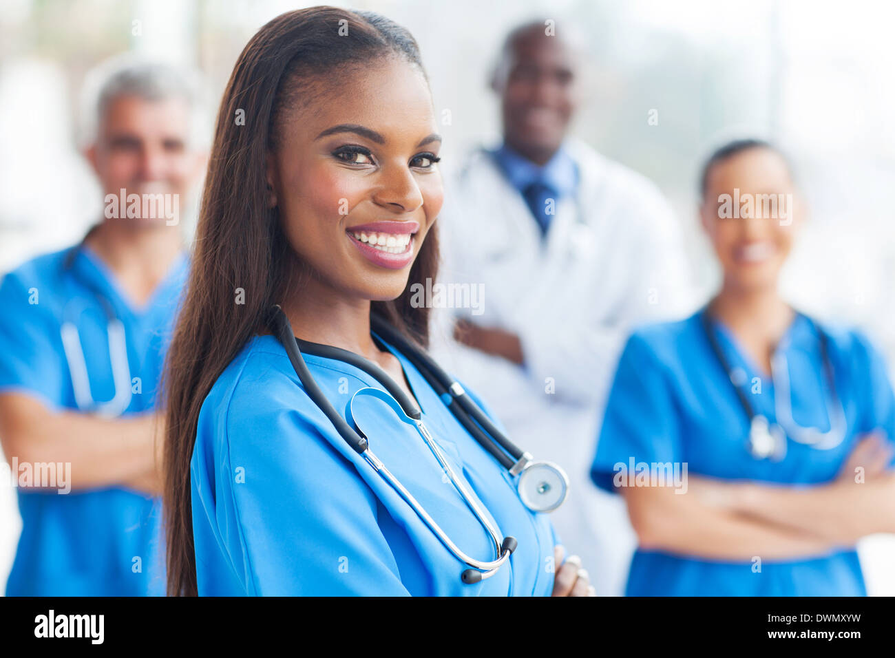 happy African female nurse with colleagues on background Stock Photo ...