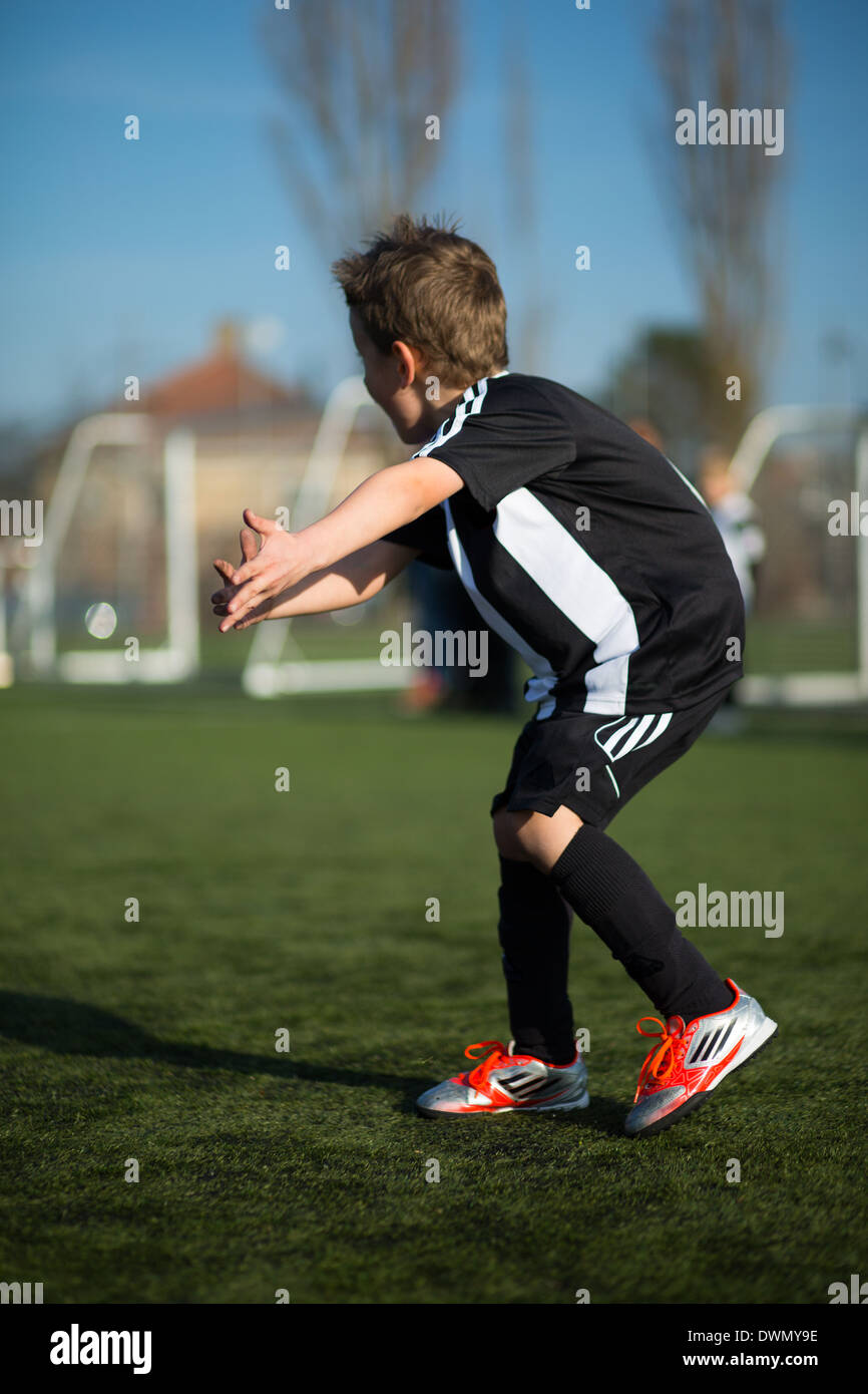 Young boy complaining to his team mates. Trademarks have been removed ...