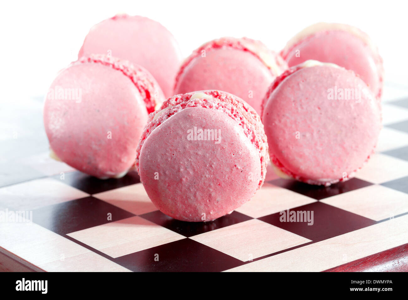 Pink French macarons on a chessboard Stock Photo - Alamy