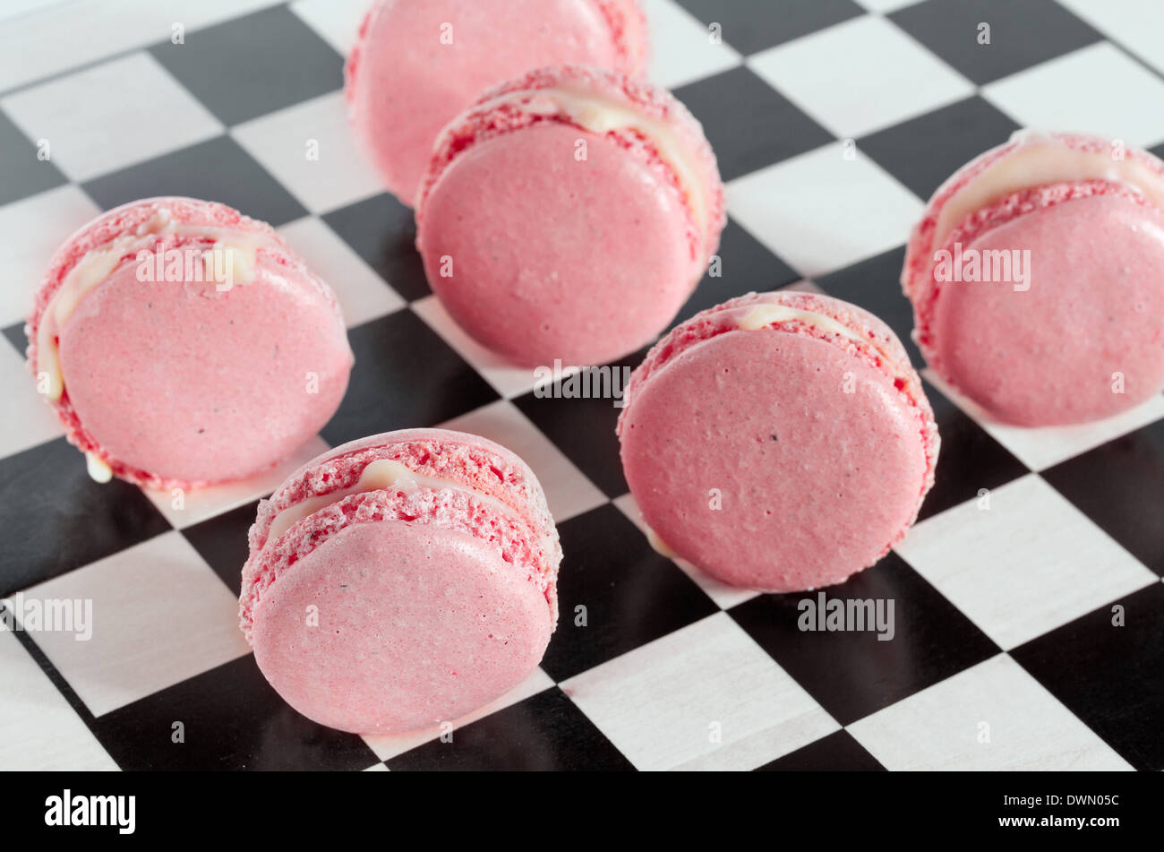 Pink French macarons on a chessboard Stock Photo - Alamy
