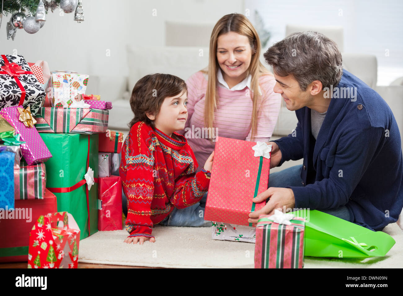 Child receiving christmas present hi-res stock photography and images ...
