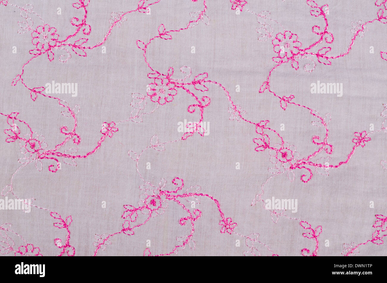 Pink embroidery craft on a light cotton fabric Stock Photo - Alamy