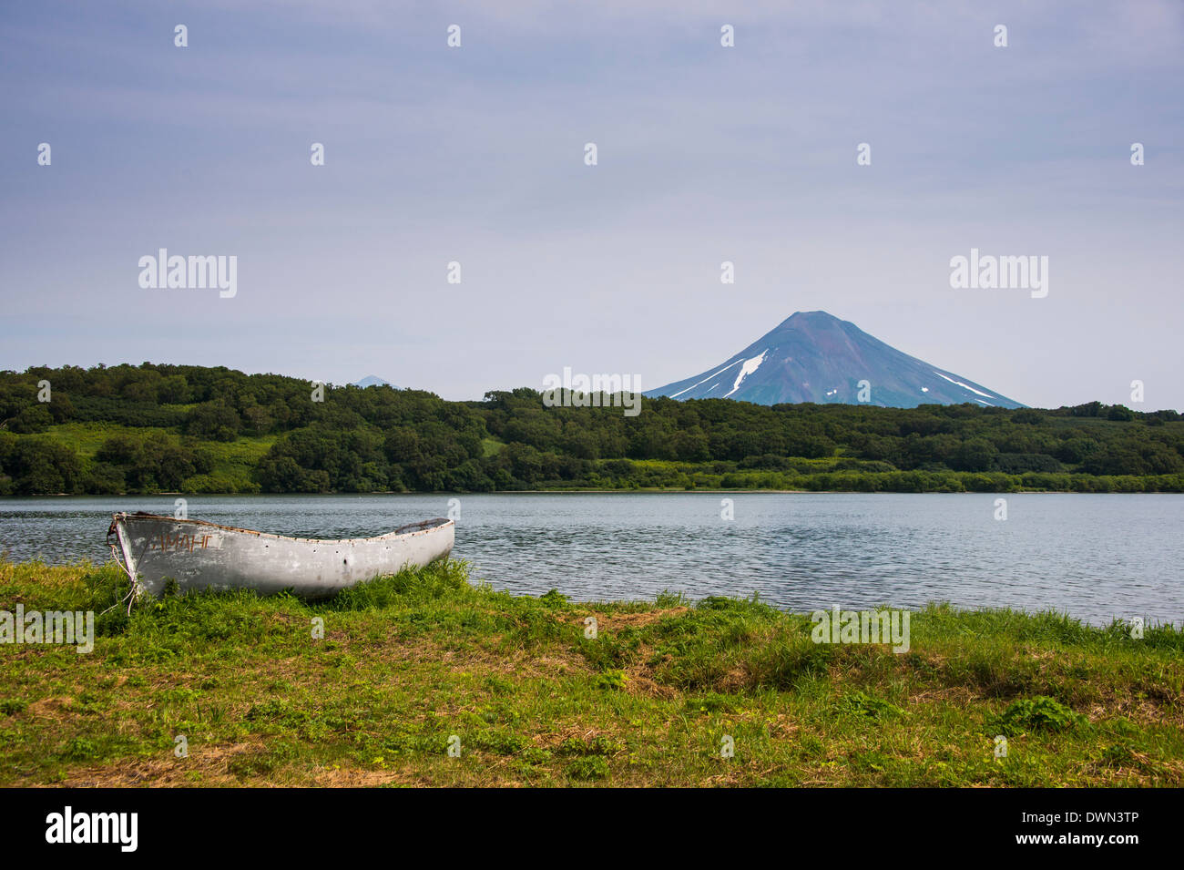 Wooden canoe in front of the Ilyinsky (volcano) and Kurile Lake ...