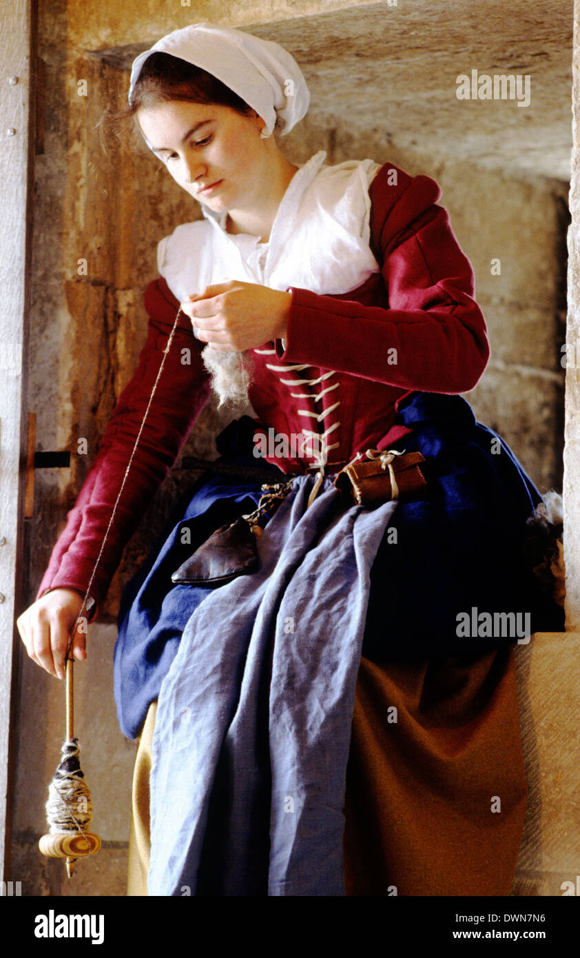 Tudor Period young woman spinning wool, late 16th century historical re ...