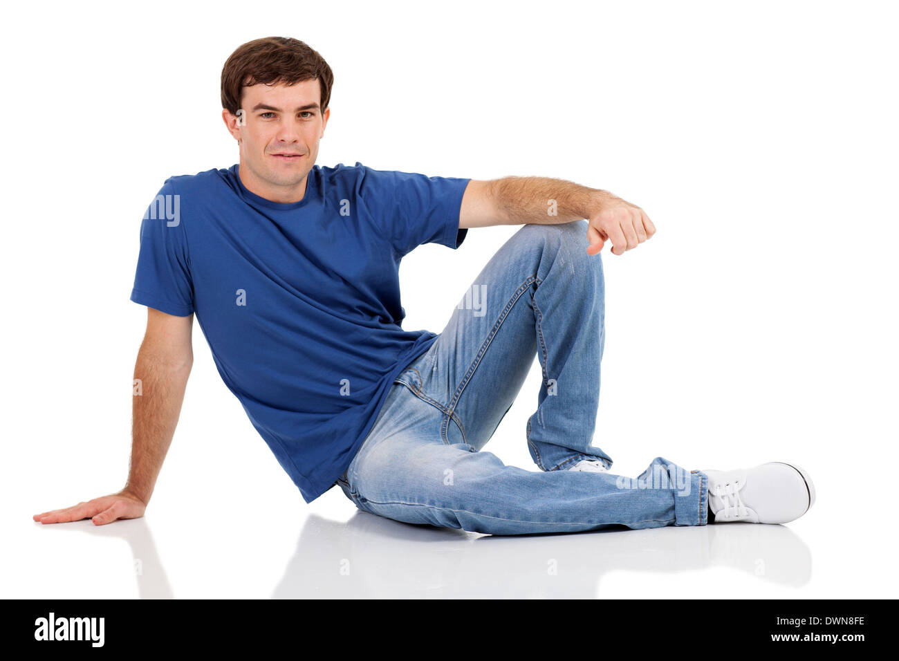 portrait of casual man sitting on the floor over white background Stock ...