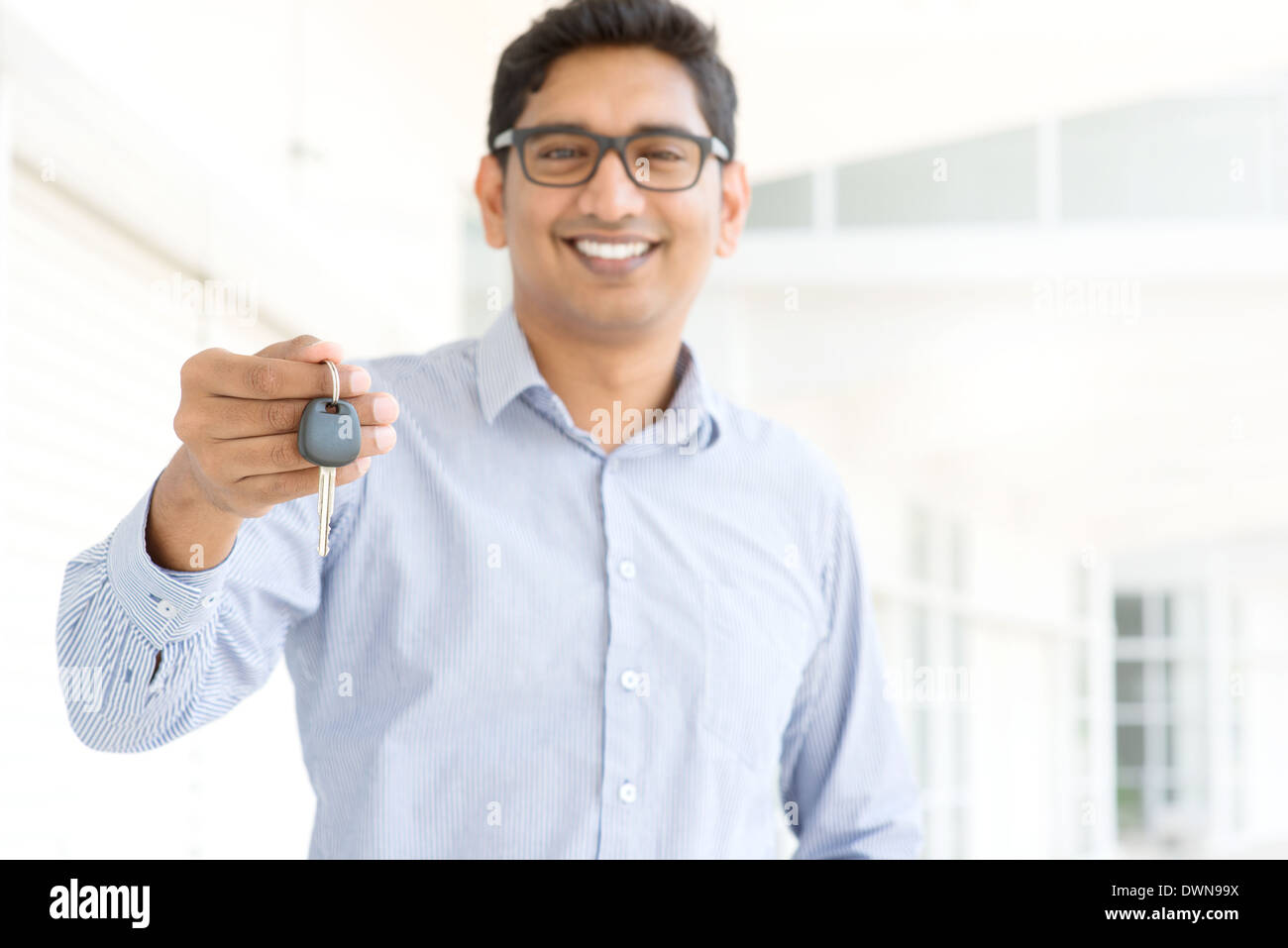 Young Asian Indian estate agent or salesman showing a key, India male ...