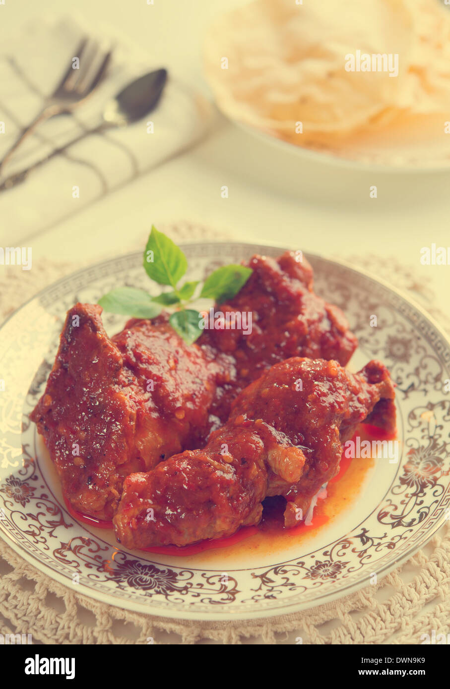 Indian curry chicken. Popular Indian dish on dining table in retro ...