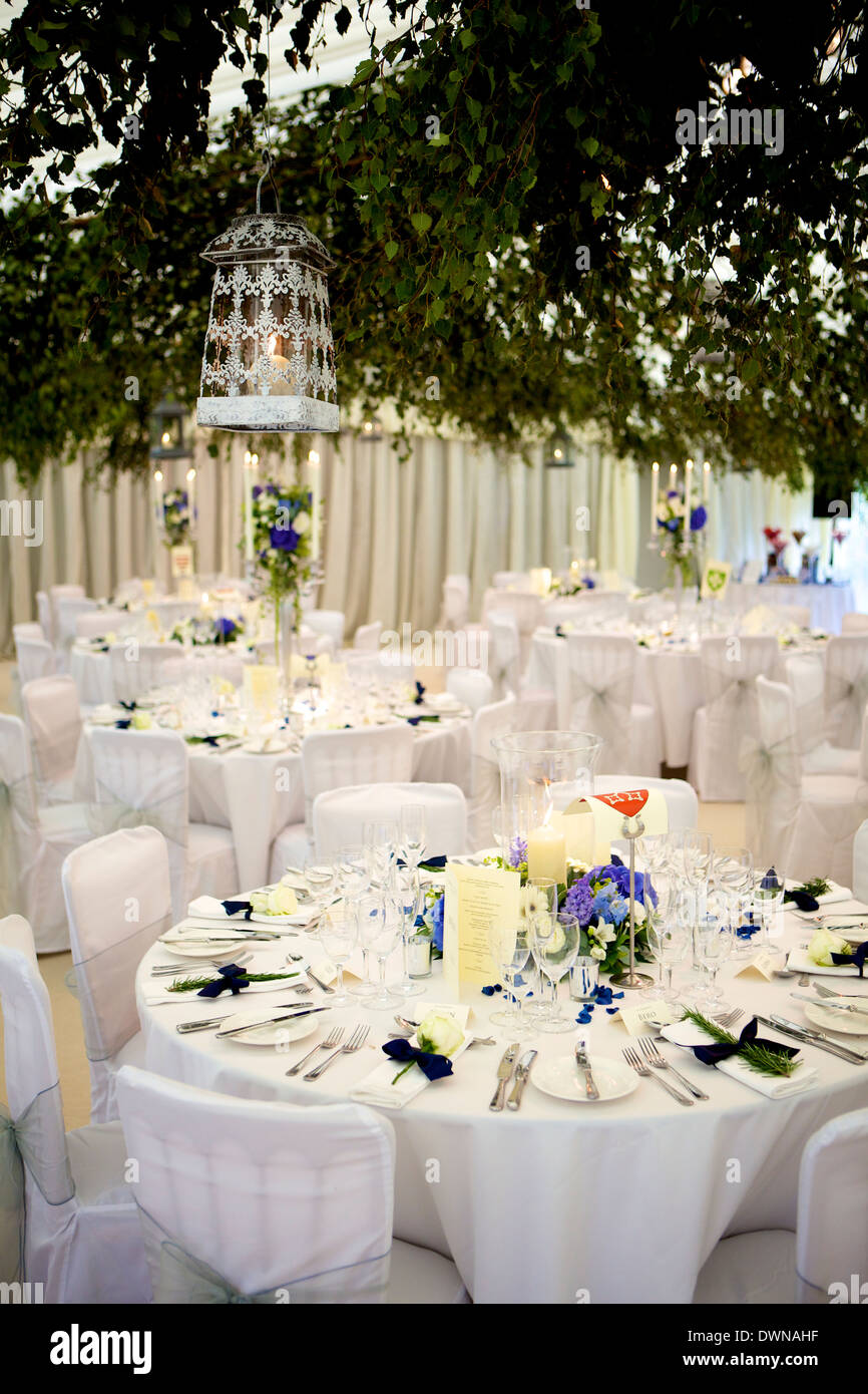 Wedding breakfast tables set up in marquee in preparation for the ...