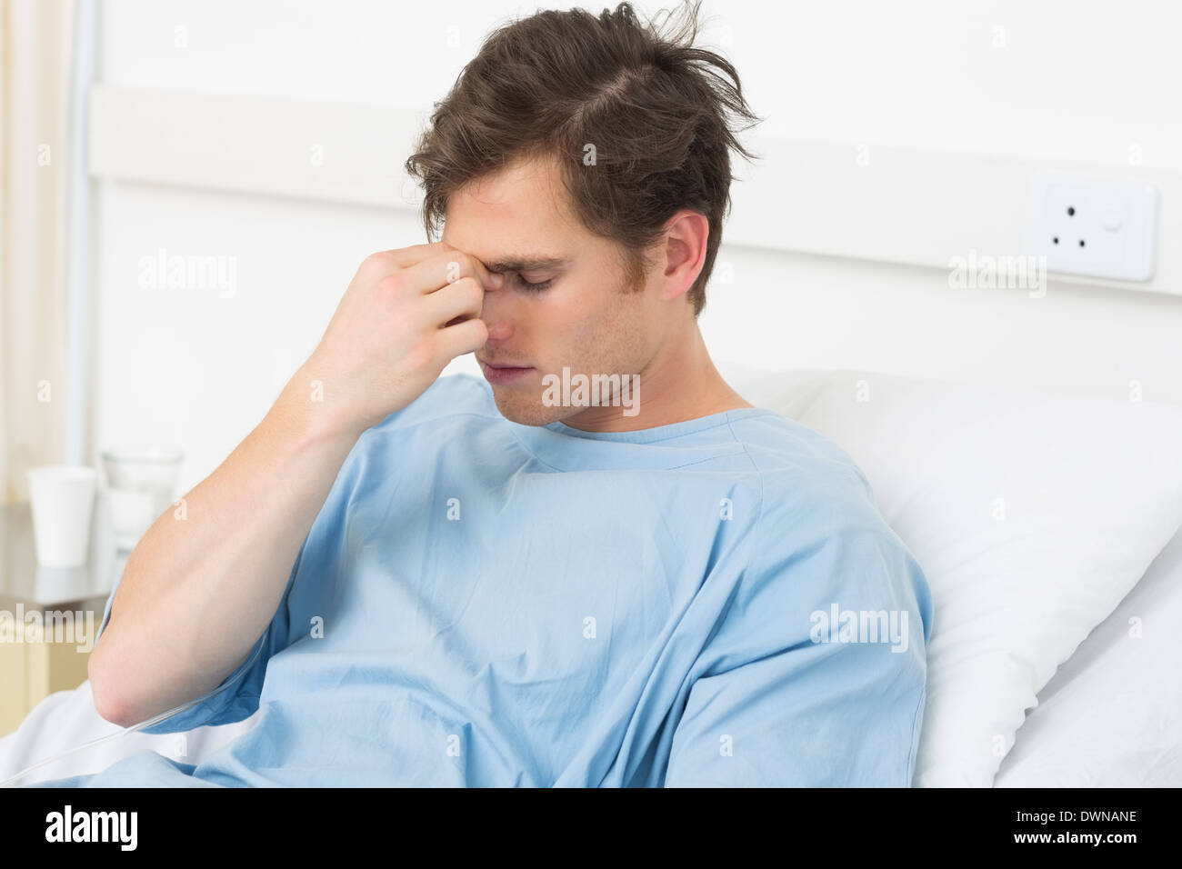Patient suffering from headache relaxing in hospital Stock Photo - Alamy