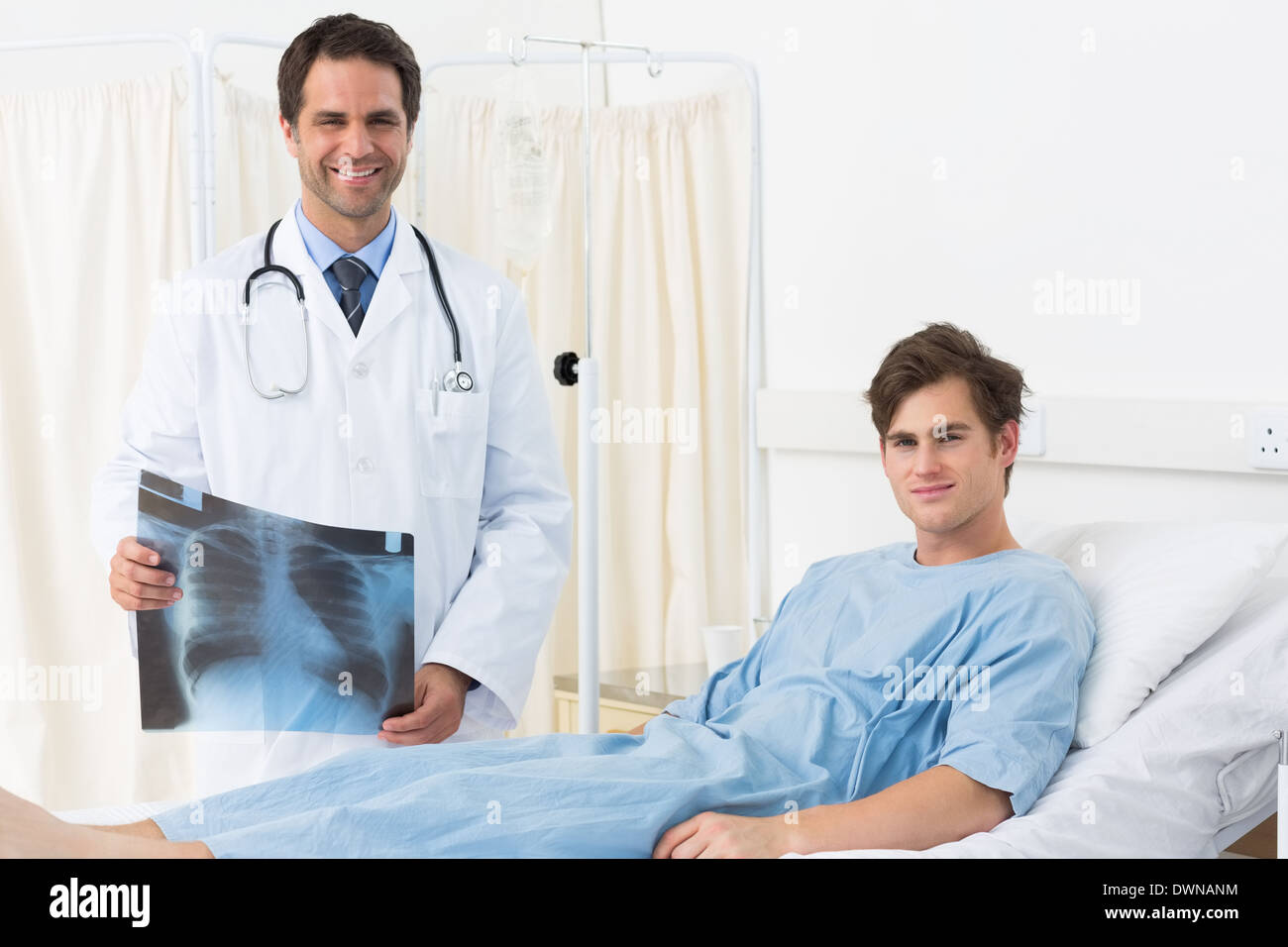 Doctor with Xray report and patient in ward Stock Photo - Alamy