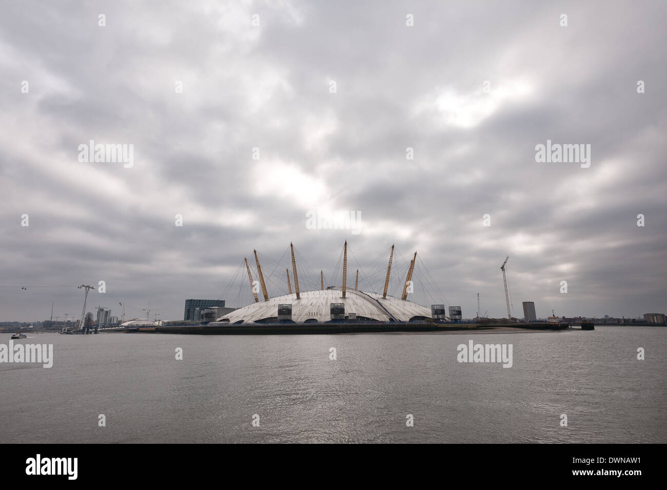 London O2 Arena shines out against a cloudy gray sky with river tames ...