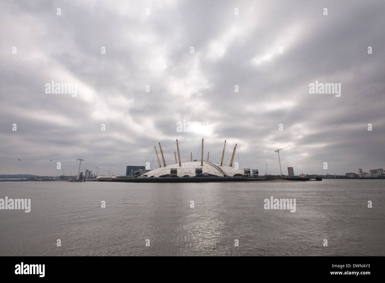 London O2 Arena shines out against a cloudy gray sky with river tames ...