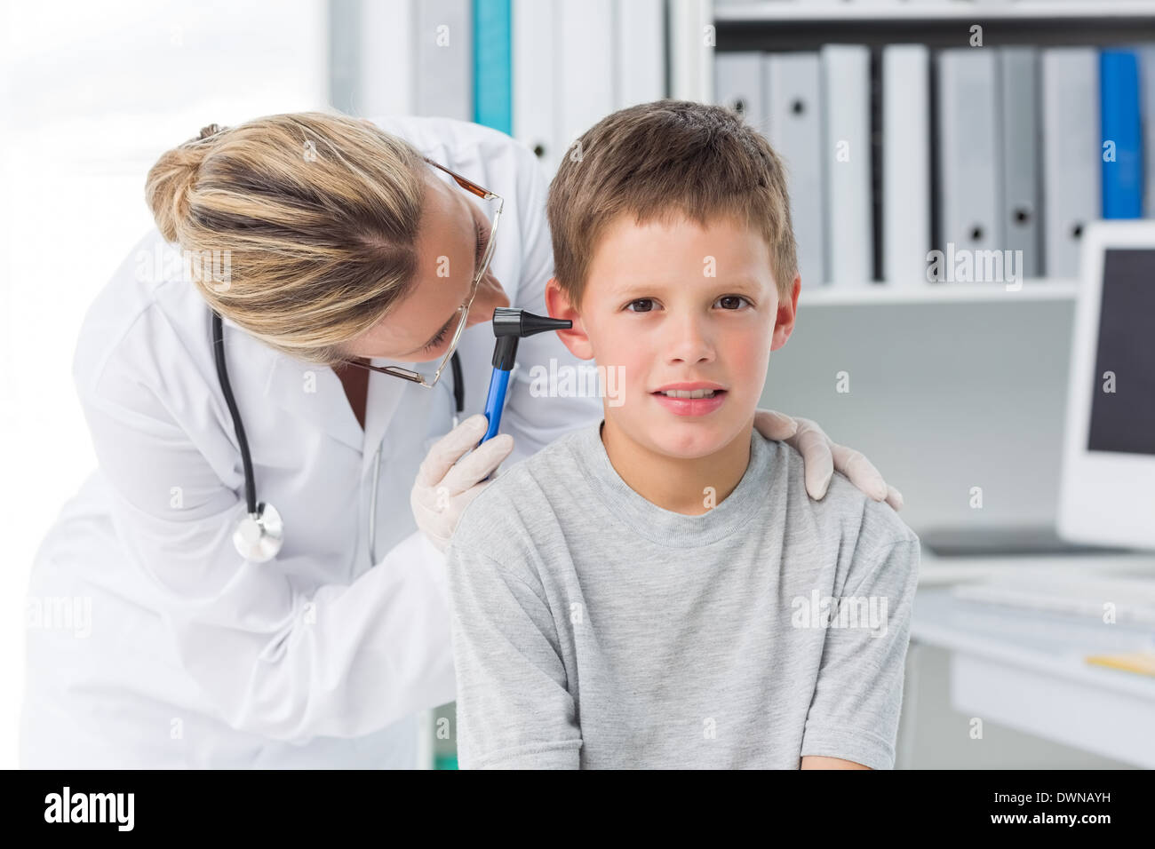 Boy being examined by doctor with otoscope Stock Photo - Alamy