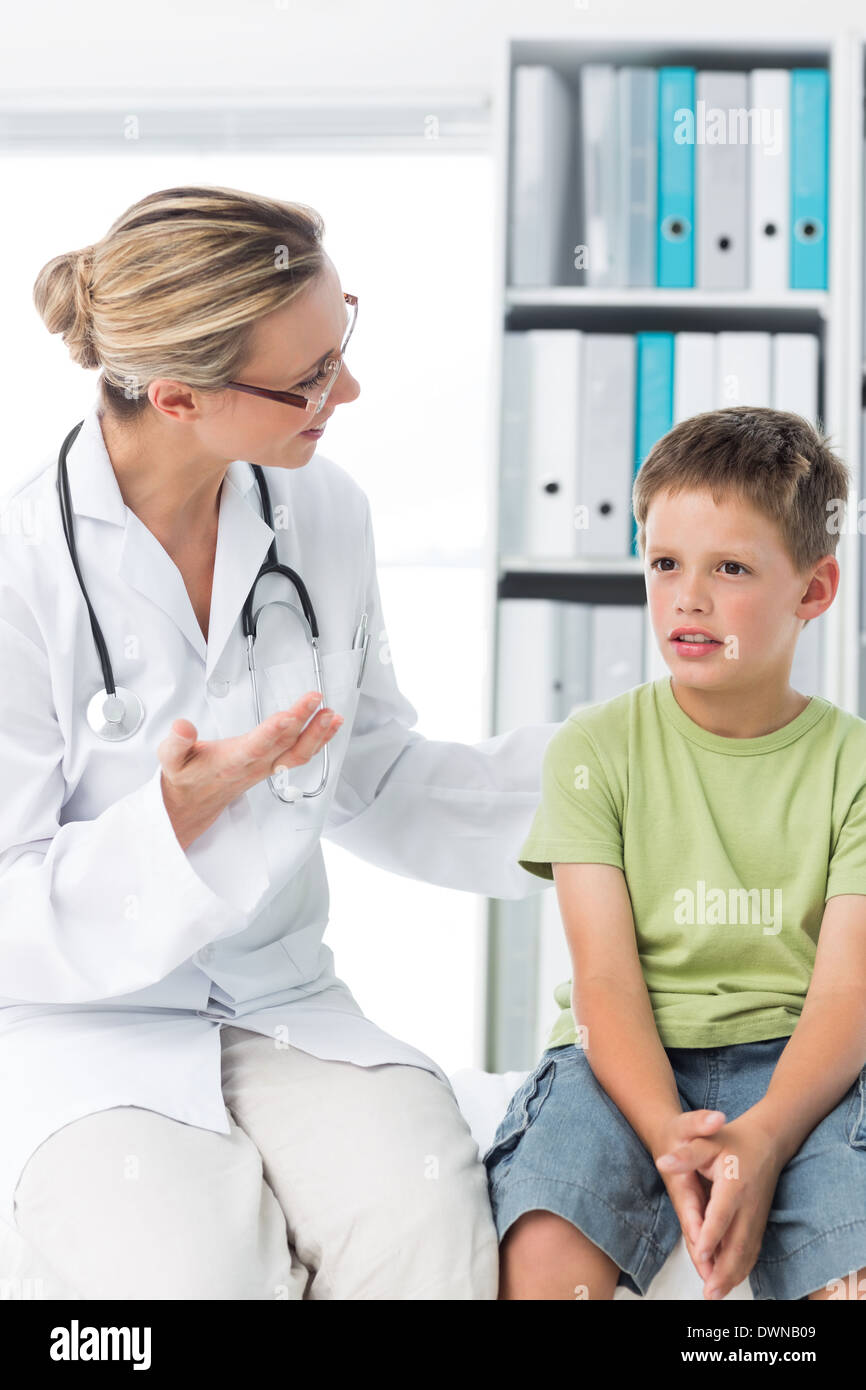 Doctor talking with boy in clinic Stock Photo - Alamy