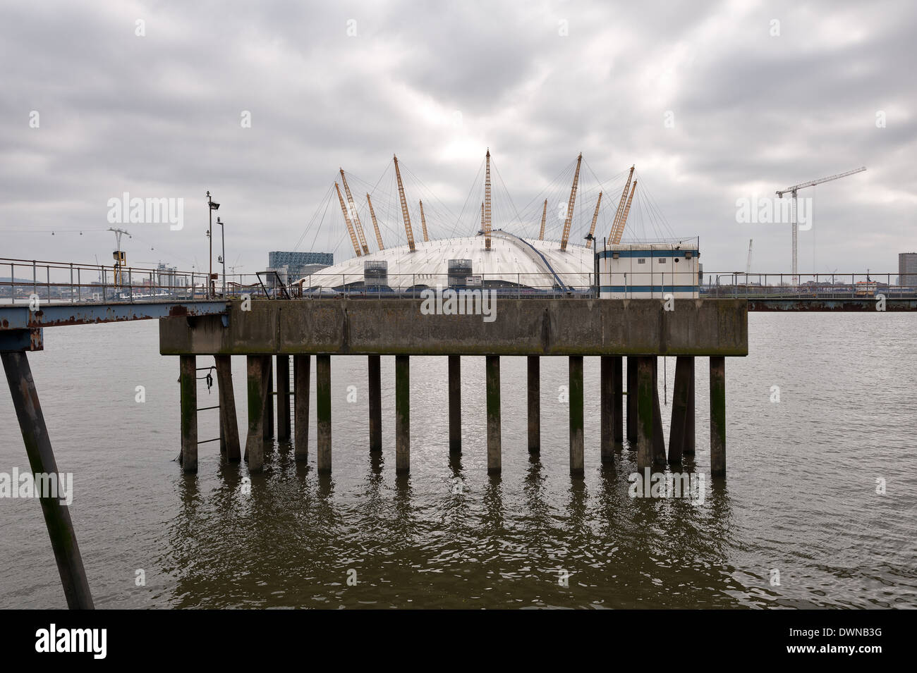 London O2 Arena shines out against a cloudy gray sky with river tames ...