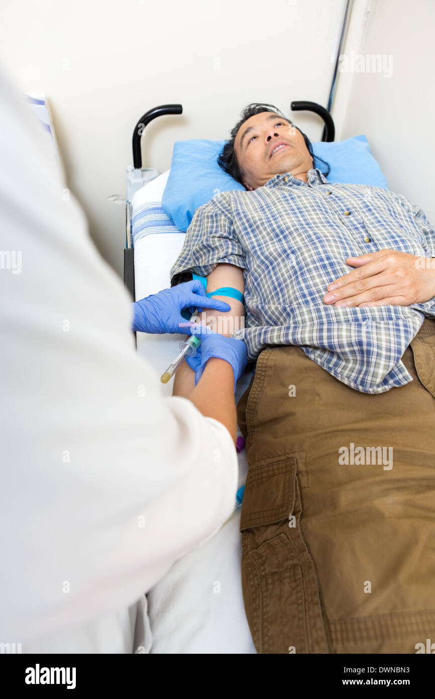 Doctor Drawing Blood From Patient's Arm Stock Photo - Alamy