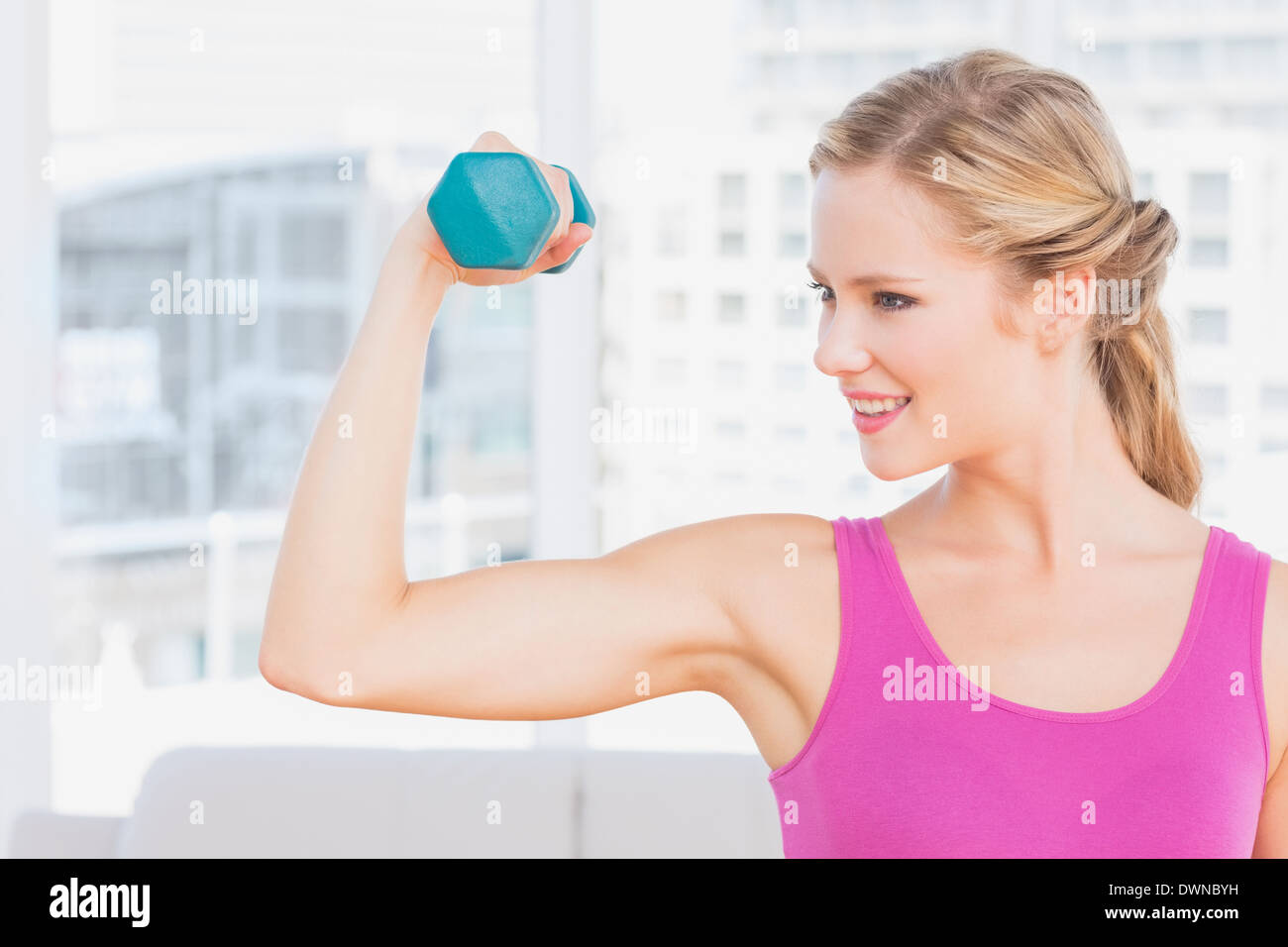 Happy woman dumbbell flexing hi-res stock photography and images - Alamy