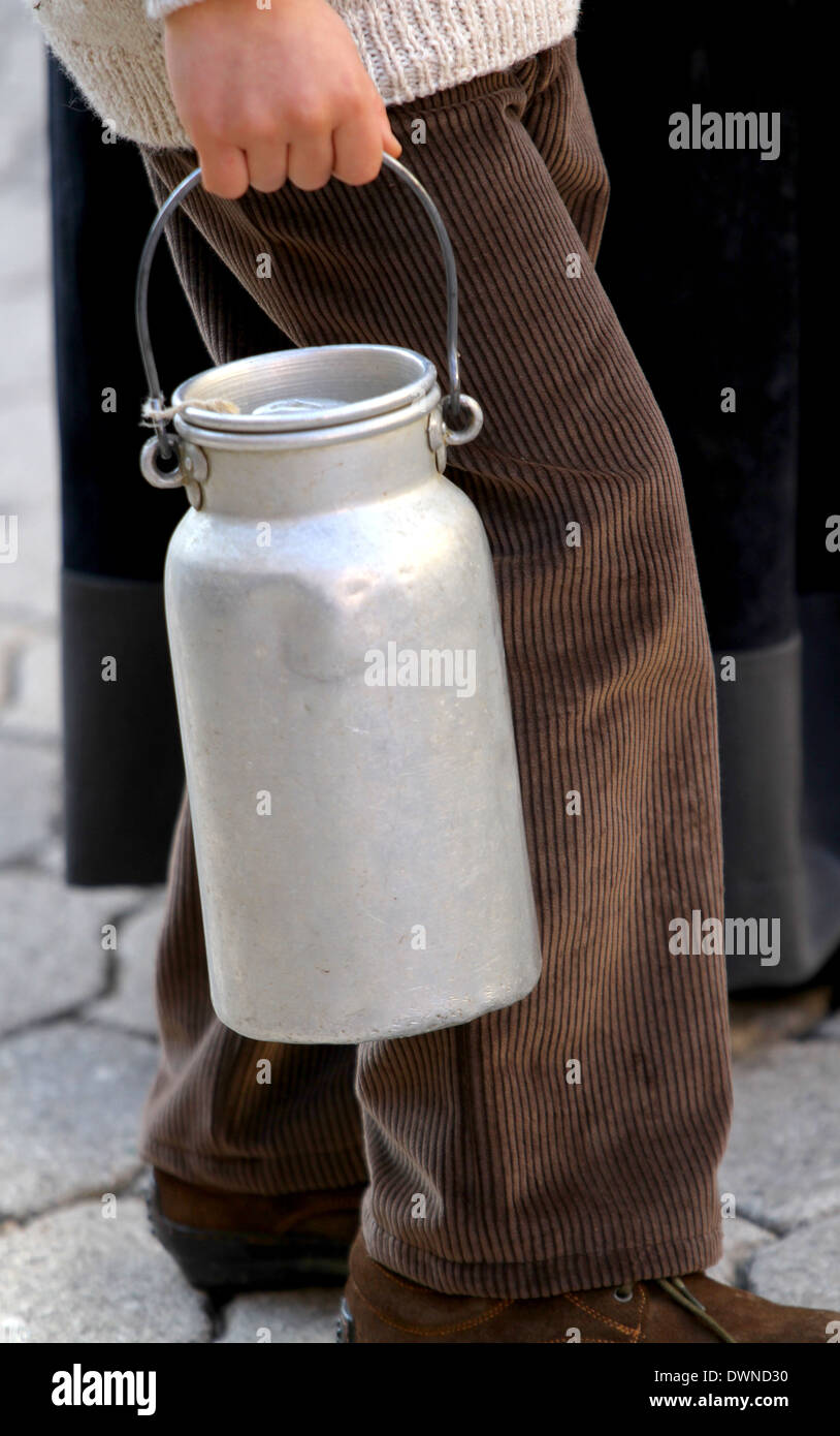 ancient old bin to transport the milk brought by a young boy Stock ...
