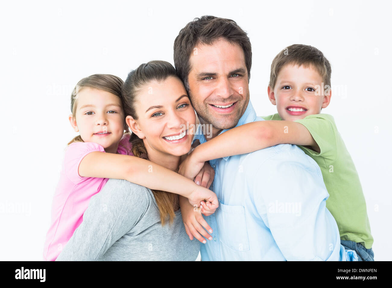 Happy young family looking at camera together Stock Photo - Alamy