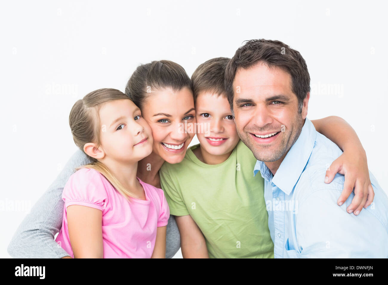 Cute family smiling at camera together Stock Photo - Alamy