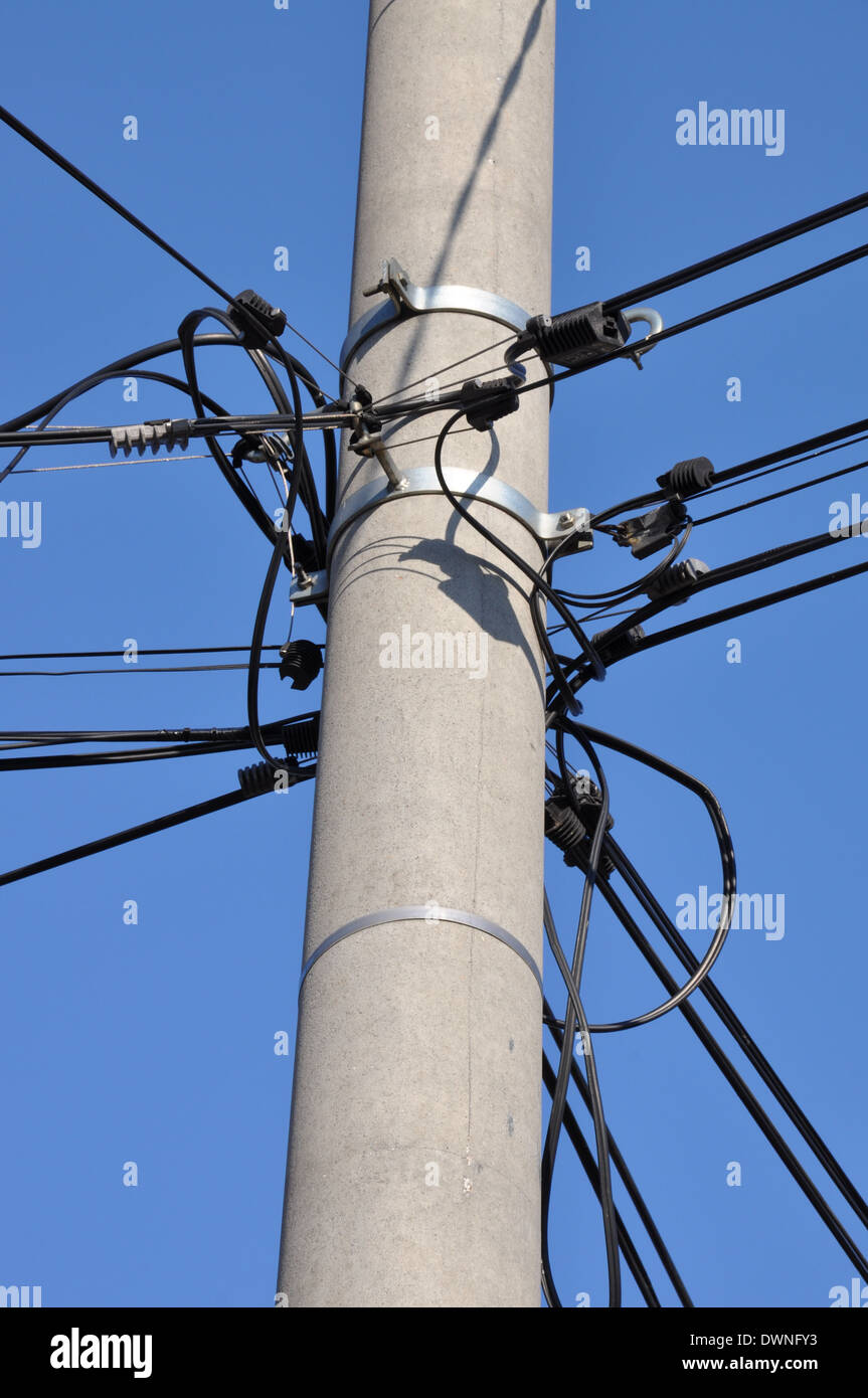 Telephone cable lines on a pole against a blue sky Stock Photo - Alamy