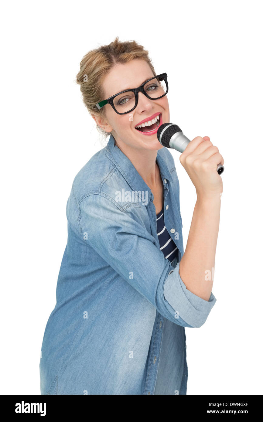 Portrait of beautiful woman singing into a microphone Stock Photo - Alamy