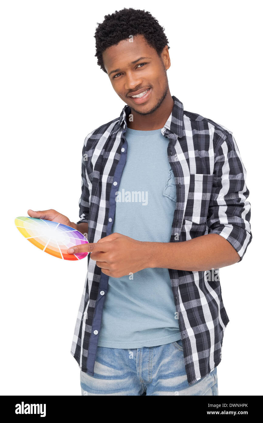 Portrait of a young man with paint samples over white background Stock ...