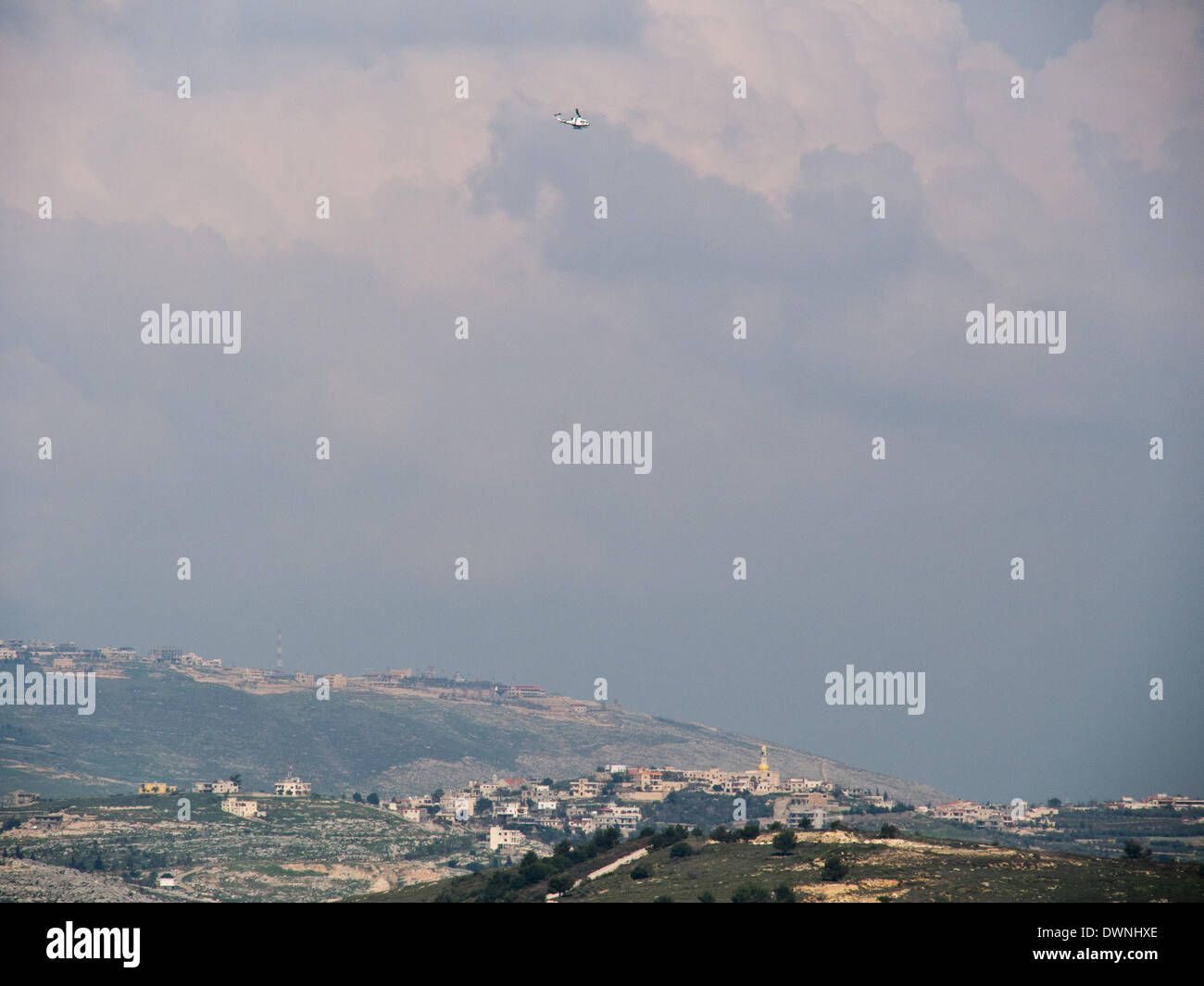 A UN helicopter flies over the town of Bint Jbeil in Southern Lebanon ...